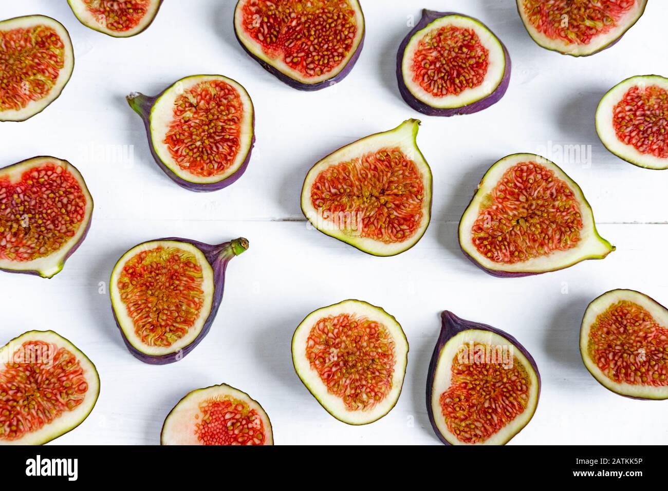 Pattern of sliced figs on a white background. Close-up photo of chopped ...