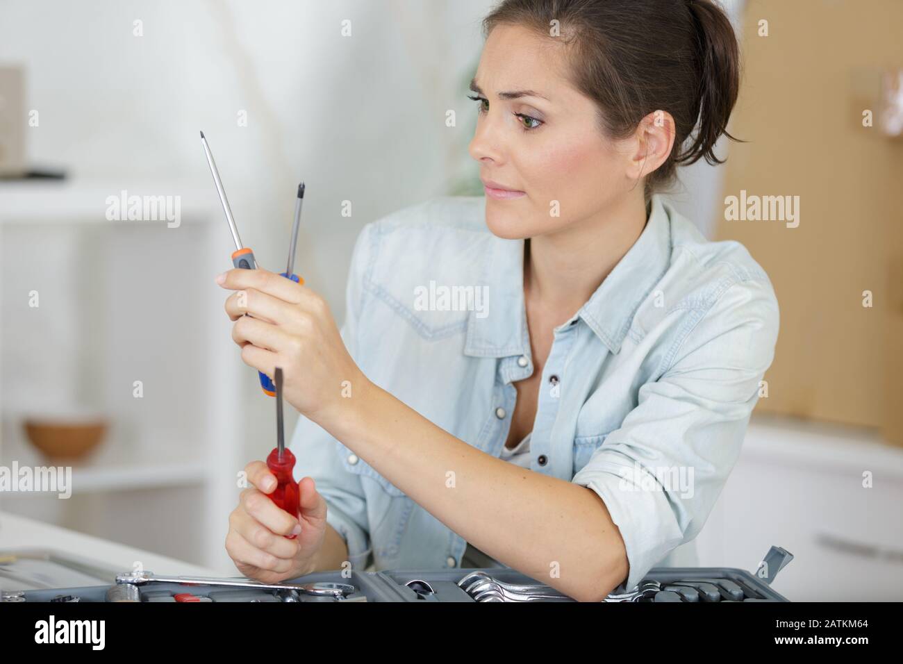 confused woman doing diy work Stock Photo - Alamy