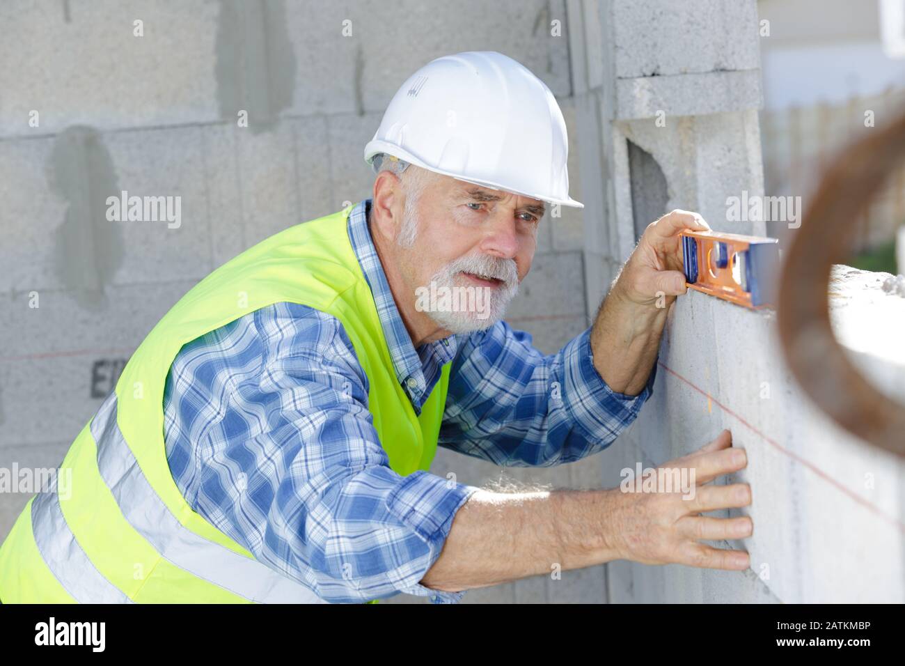 senior male worker measuring wall Stock Photo - Alamy