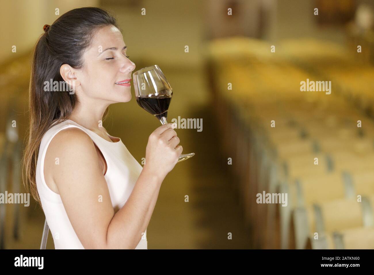 beautiful woman sommelier tasting red wine in wine cellar Stock Photo ...
