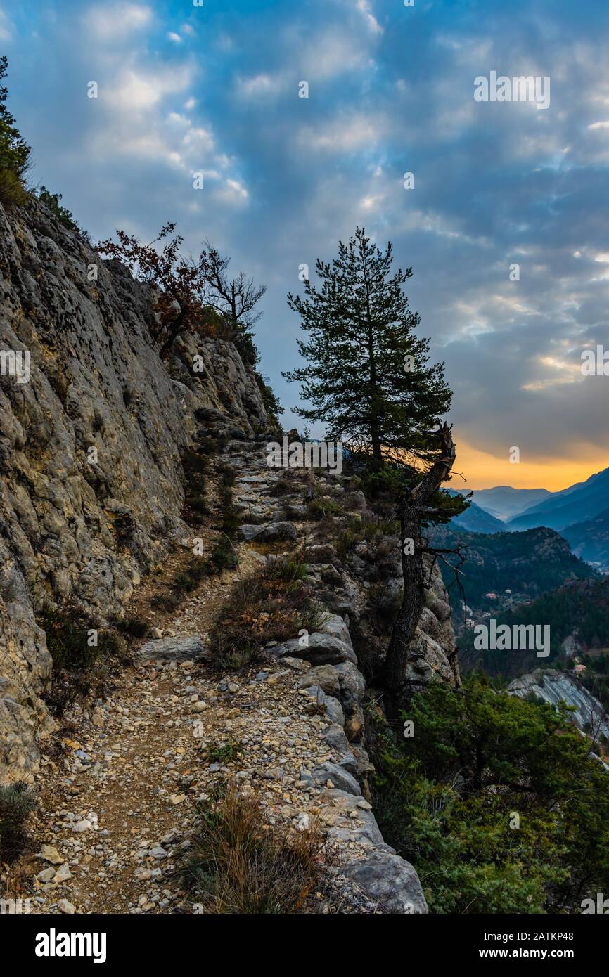 The hiking pathway close to the edge of the cliffs in the French Alps ...