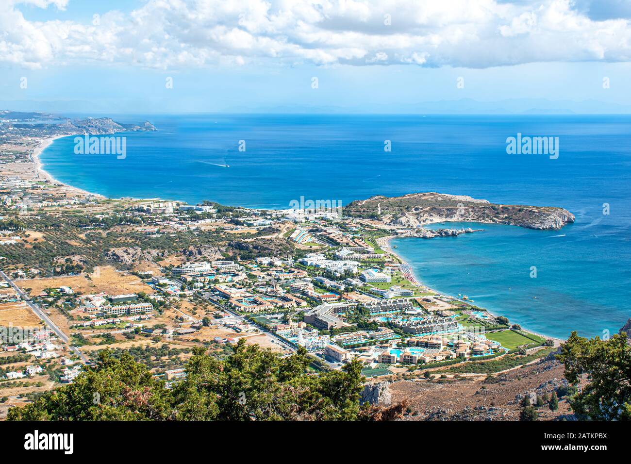 Aerial view of Kolymbia, hotel resorts with swimming pools, olive trees ...