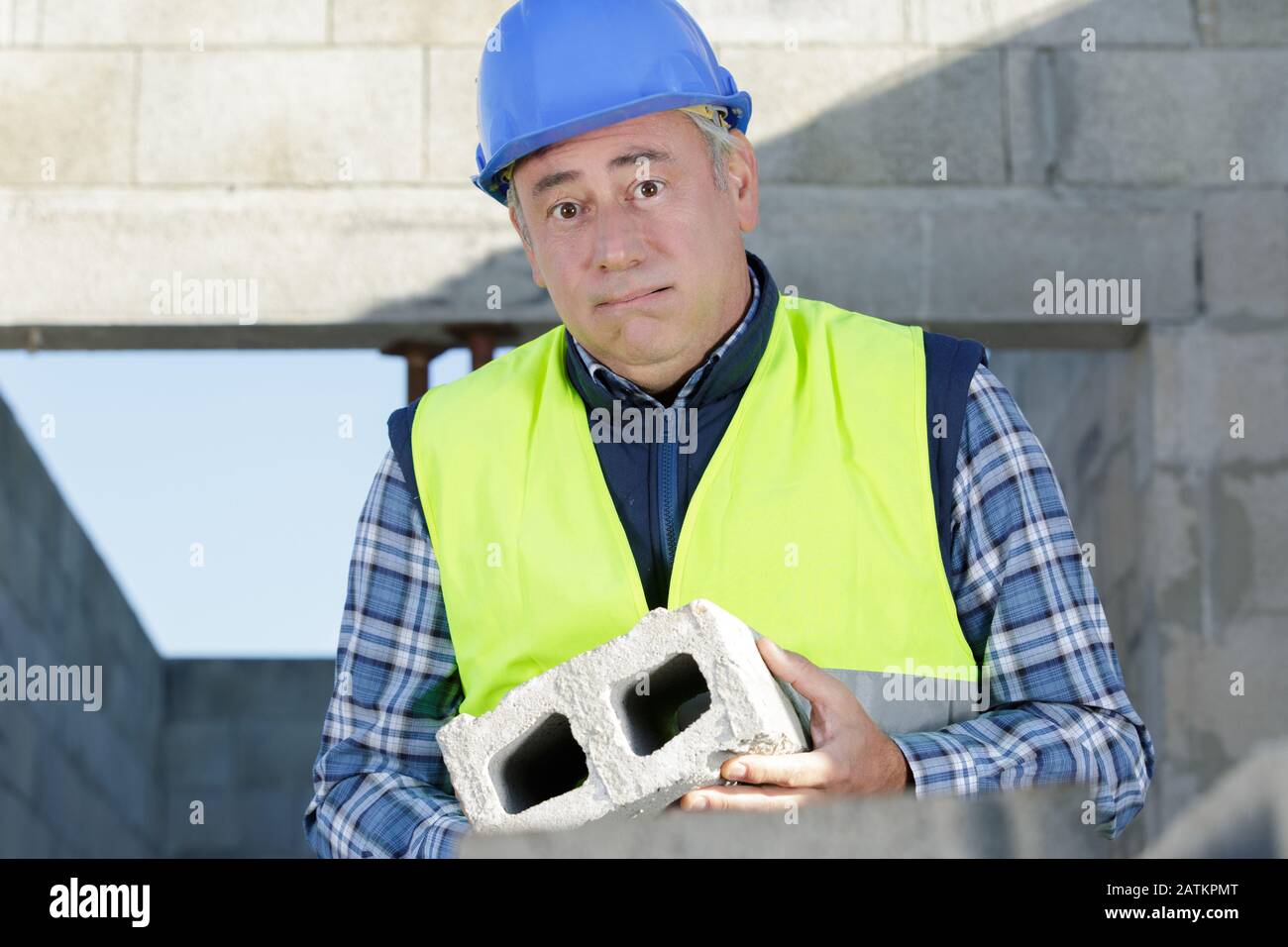 Man carrying heavy brick hi-res stock photography and images - Alamy