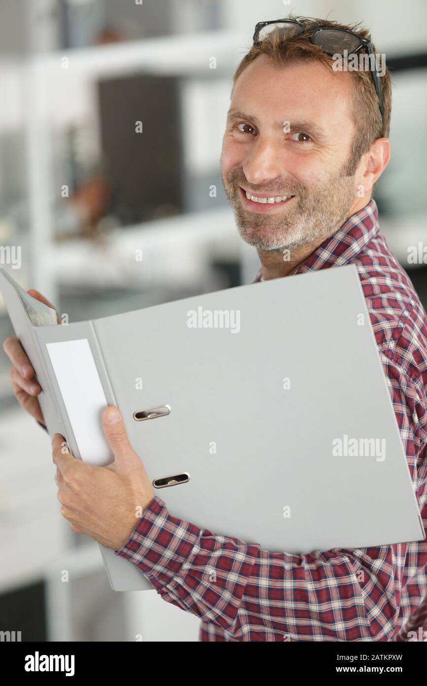 middle aged man holding an open folder Stock Photo - Alamy