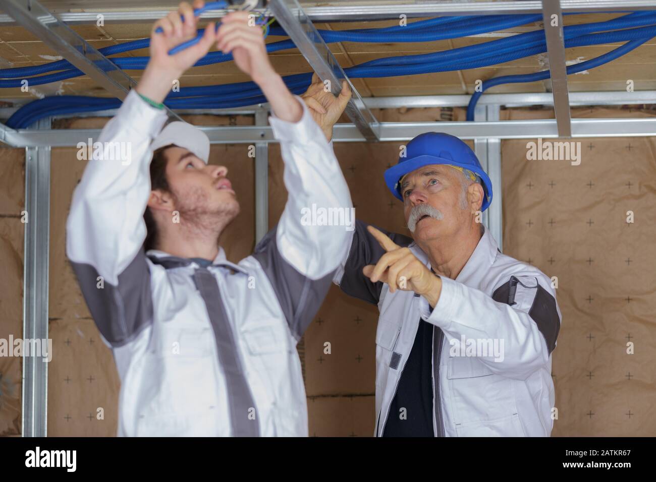 a plumber checking ceiling pipes Stock Photo - Alamy