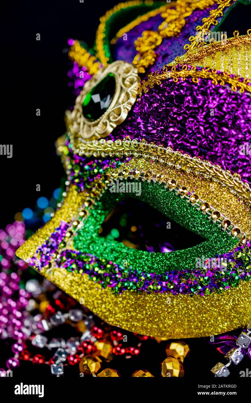 Side view of a colorful jester mask with festival beads. Cropped in ...
