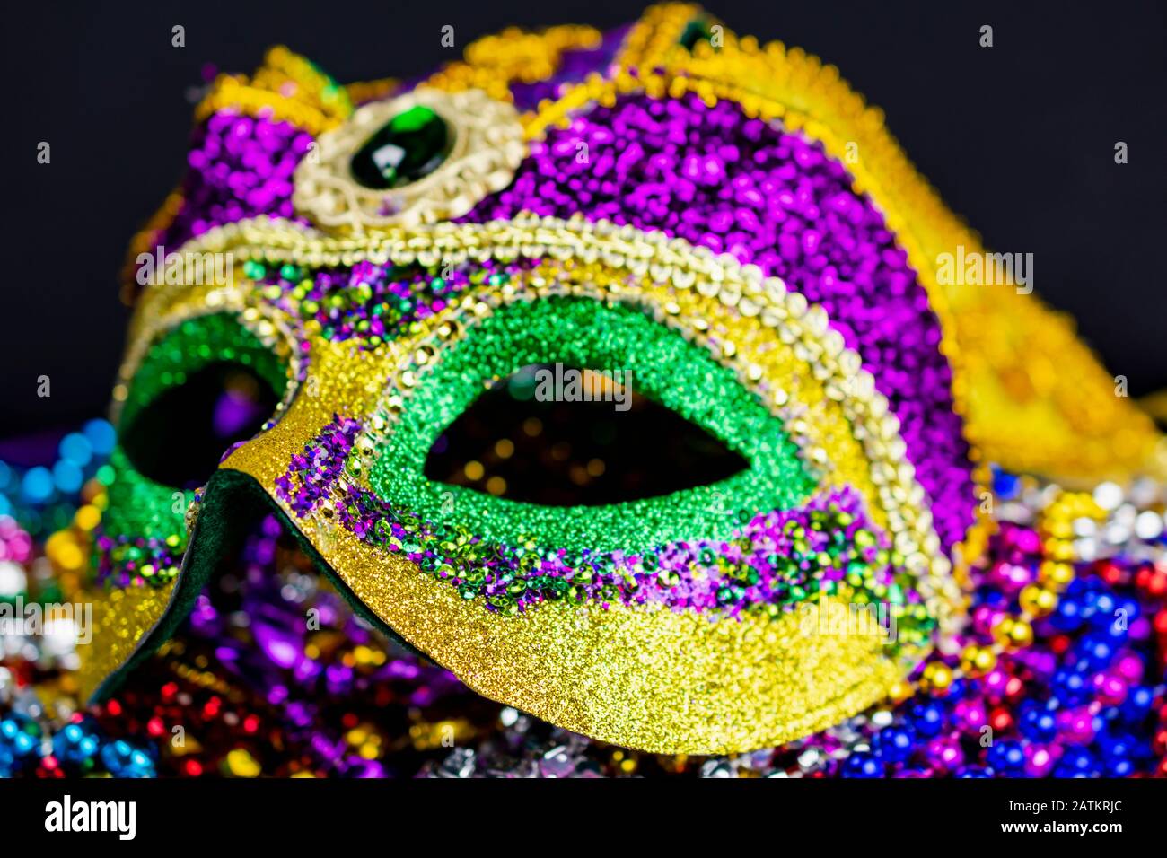 A close up view of a colorful jester mask. Selective focus on the front ...