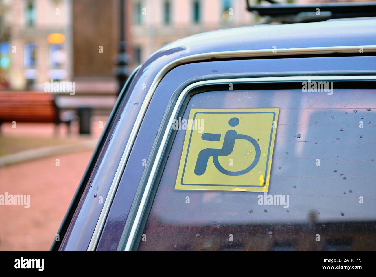 Sign of a man in an armchair - disabled person on the rear window of a ...