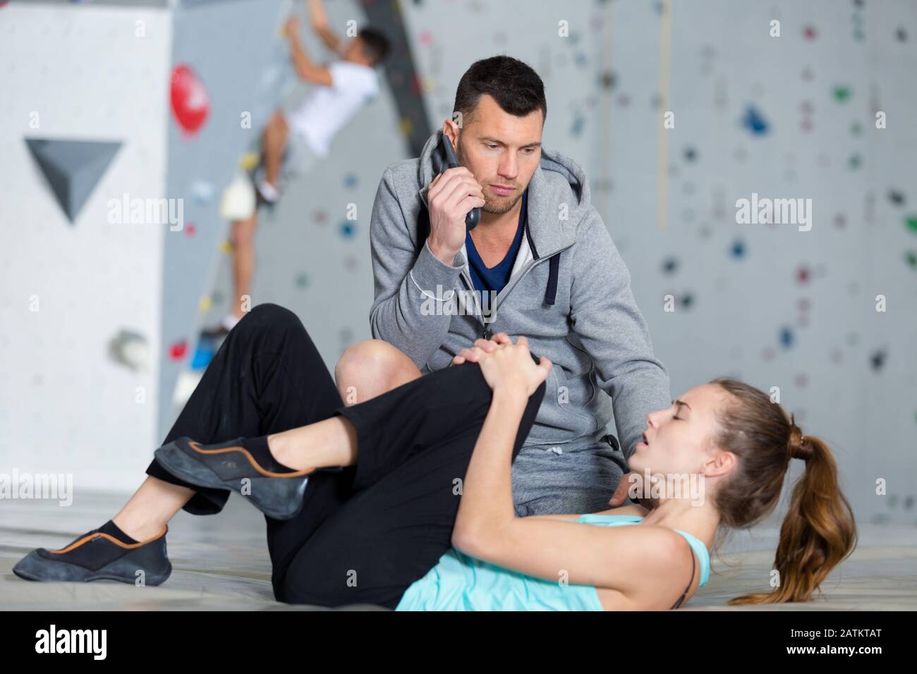man phoning for help for an injured climber Stock Photo - Alamy