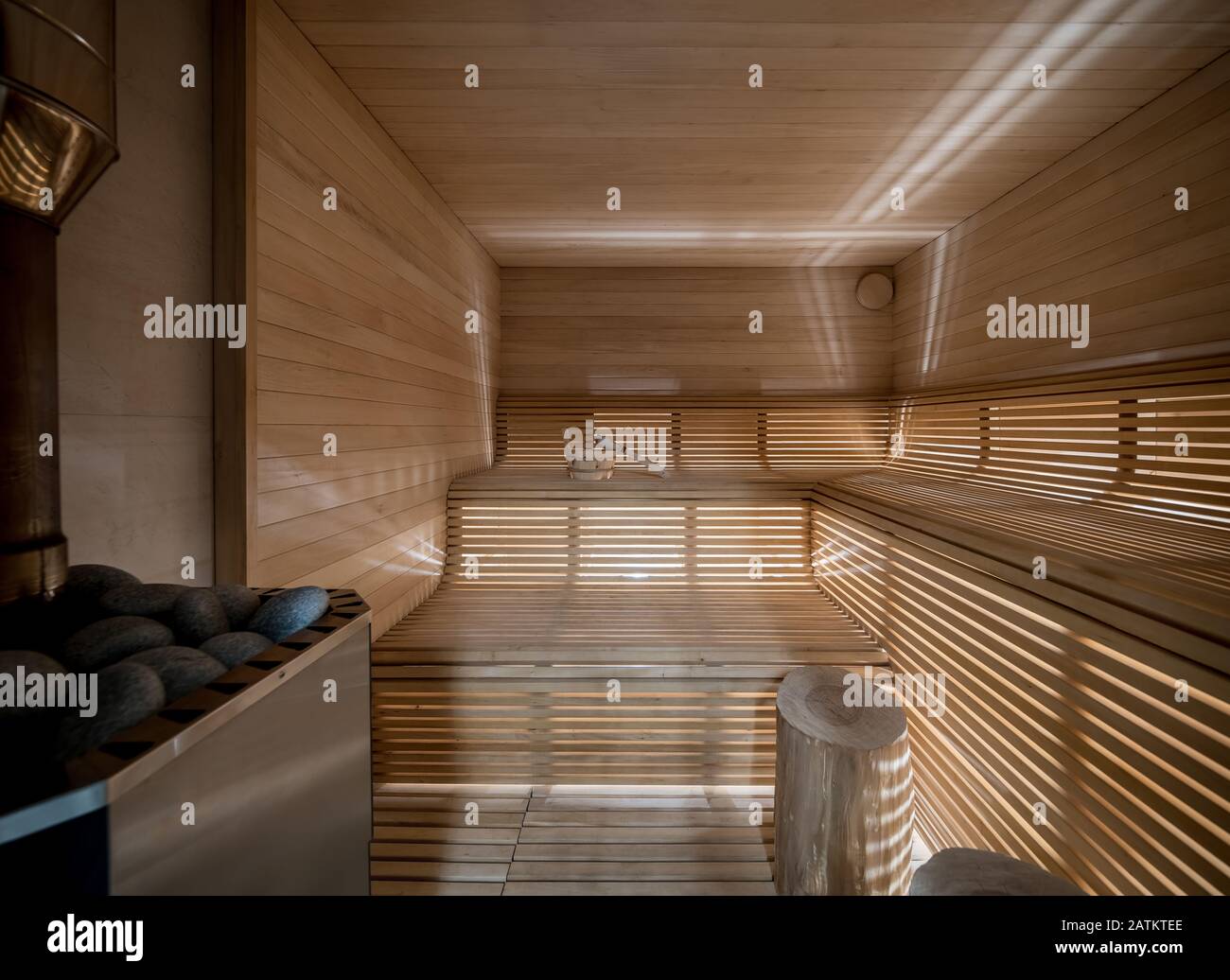 Wooden sauna with illumination. There are lattice benches, bucket with ...