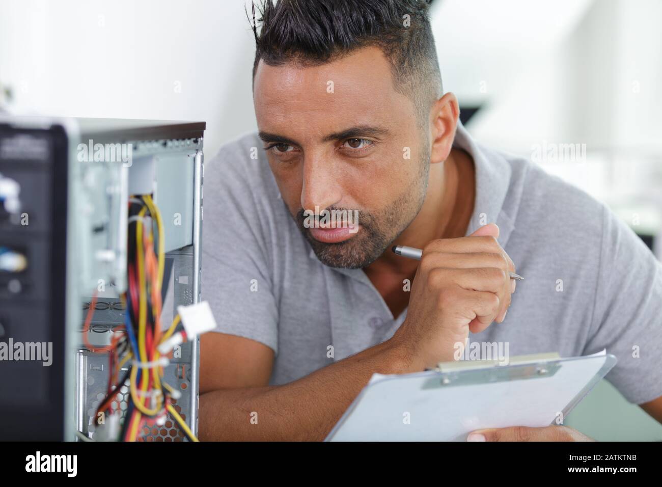a man is fixing a pc Stock Photo - Alamy