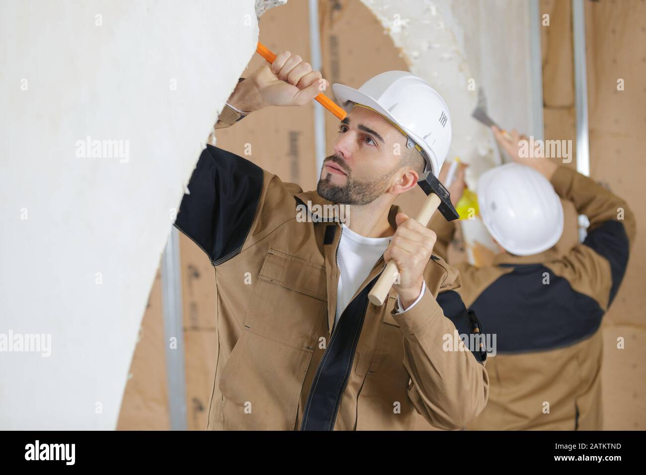 workers using hammer and chisel on interior archway Stock Photo - Alamy