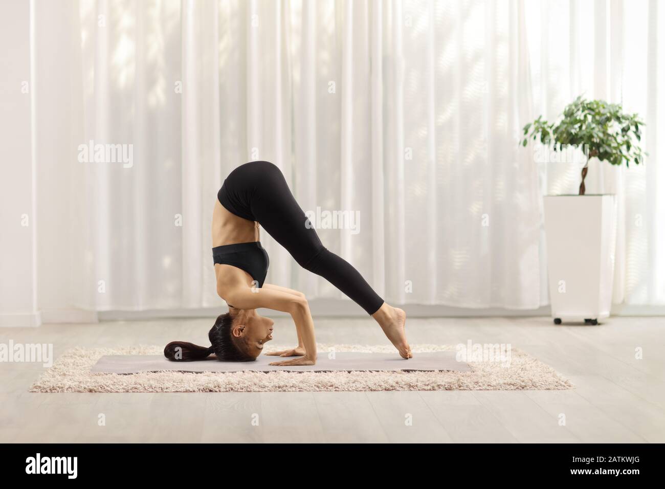 Young woman headstand hi-res stock photography and images - Alamy