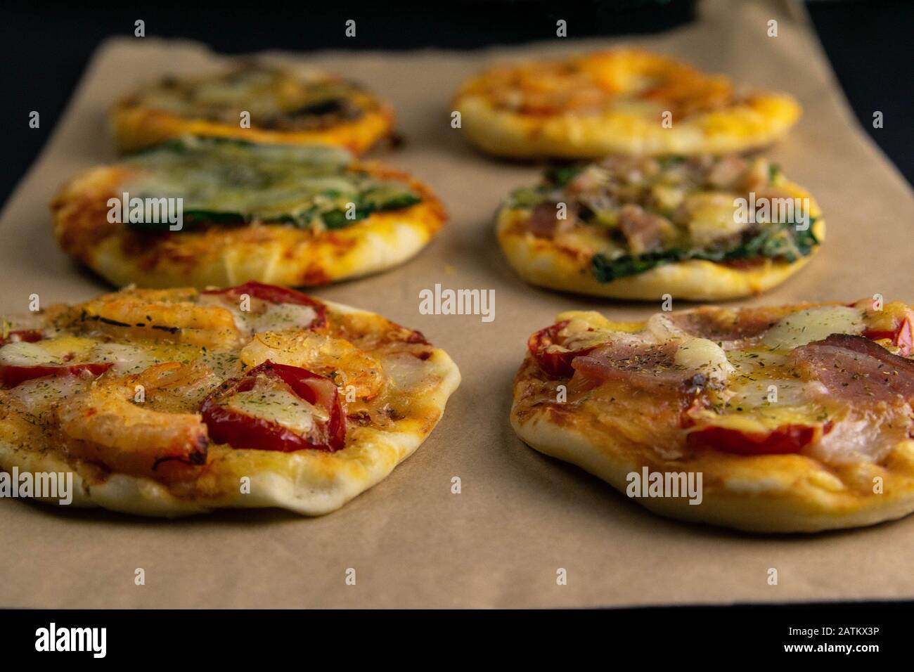 Small mini pizza. Set of different mini pizzas. Pizza on craft paper ...