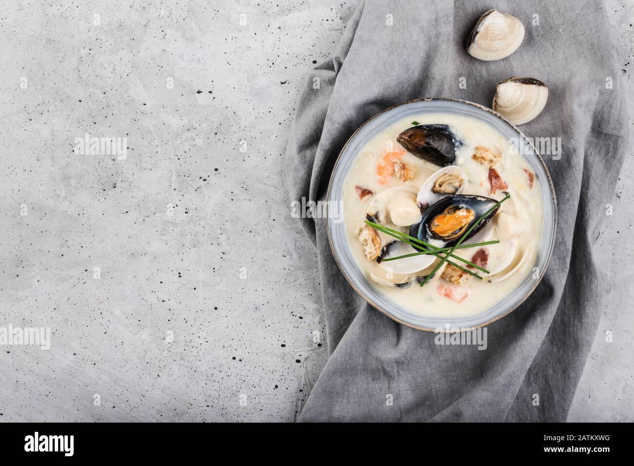 Clam chowder in a gray plate. The main ingredients are shellfish, broth ...