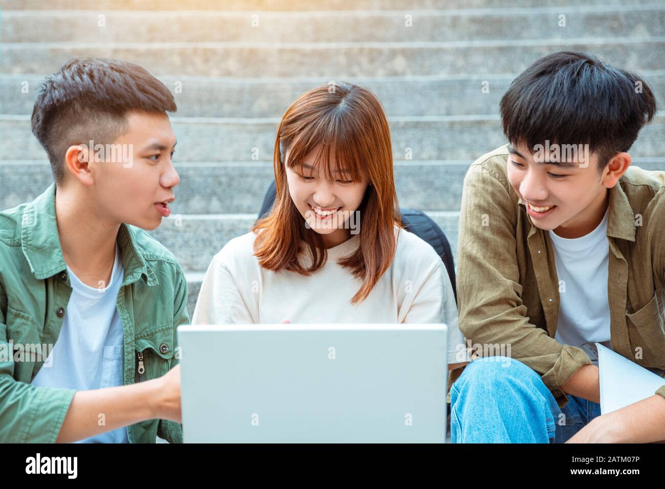 Group of students studying on the stairs at campus Stock Photo - Alamy