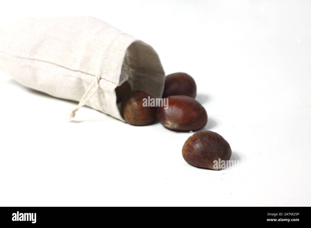 canvas bag of sweet chestnuts isolated on white background. Image ...