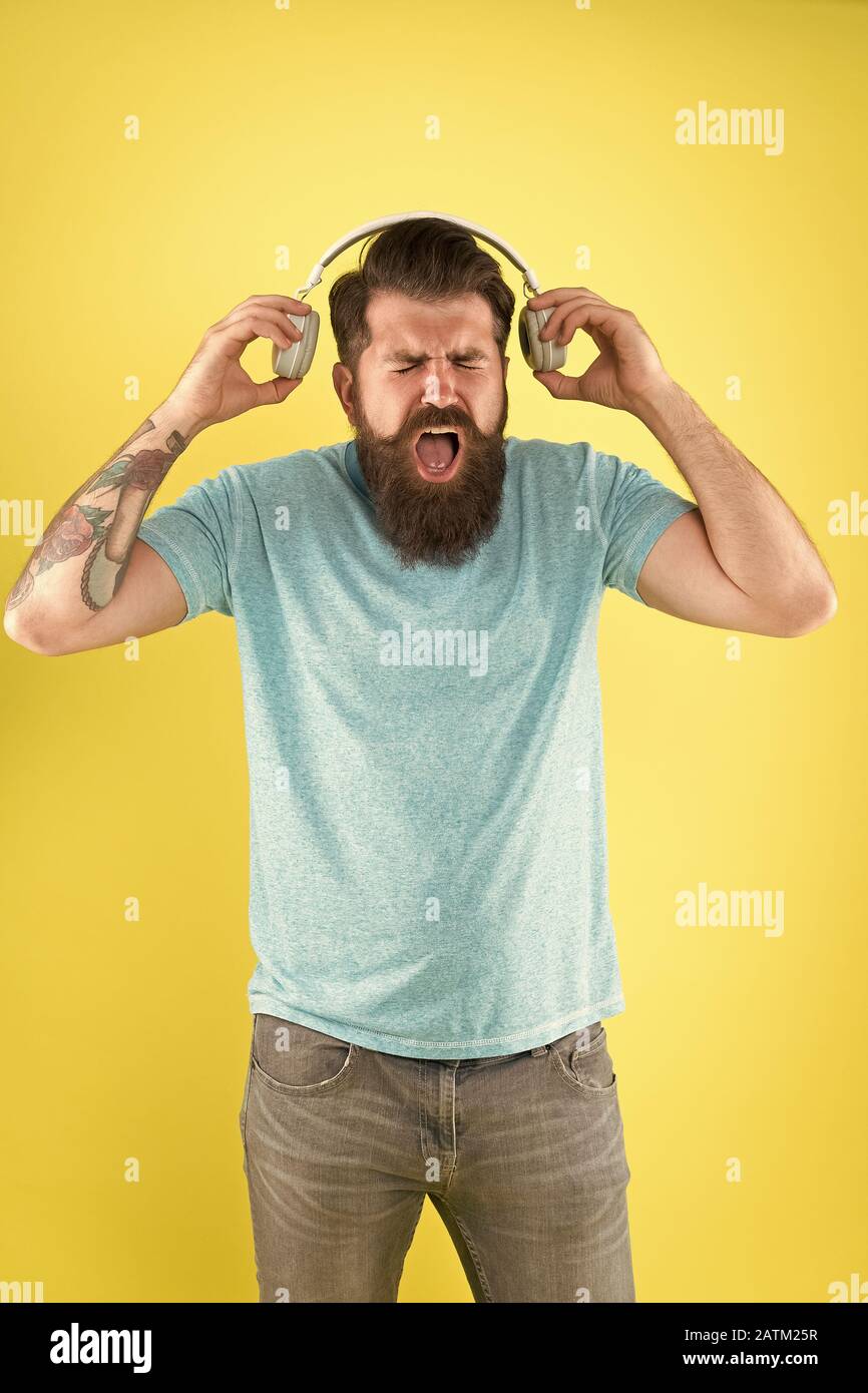 Modern music genre. Bearded man listen and sing to modern song. Modern ...