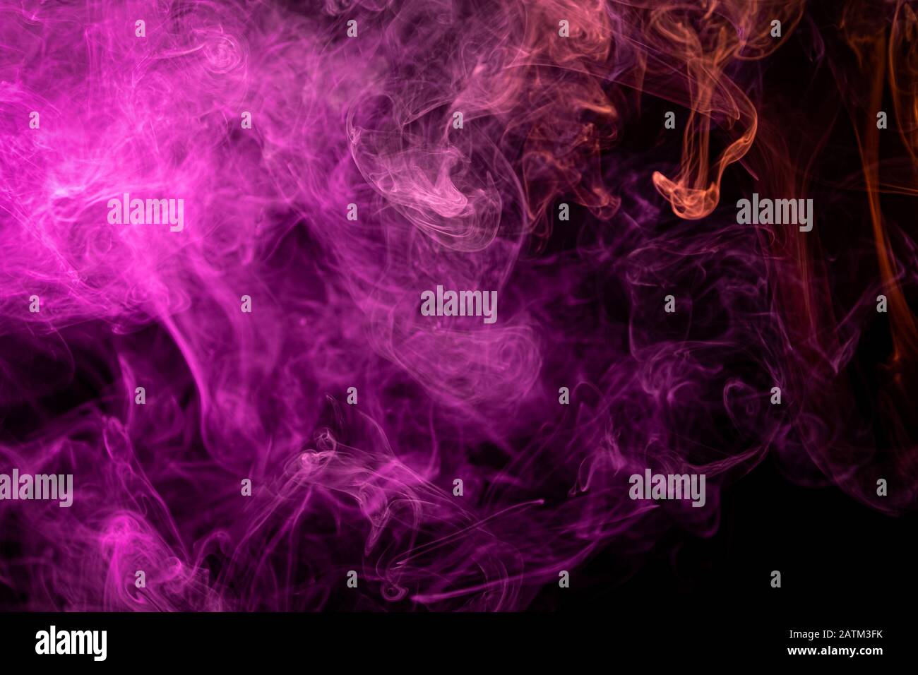 Dense multicolored smoke of pink and red colors on a black isolated ...