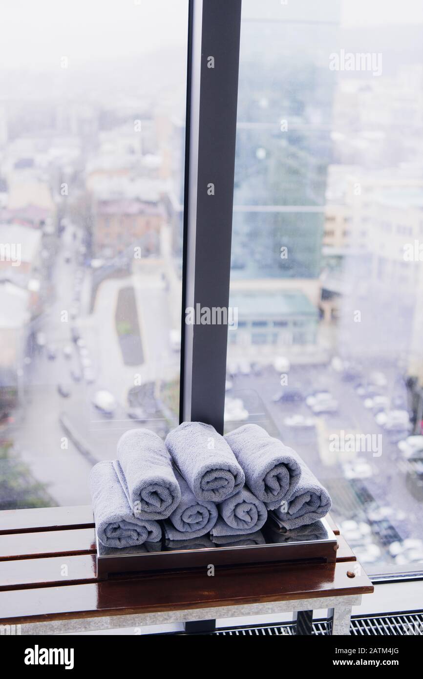 Stack of rolled towels in hotel at gym with city view Stock Photo - Alamy