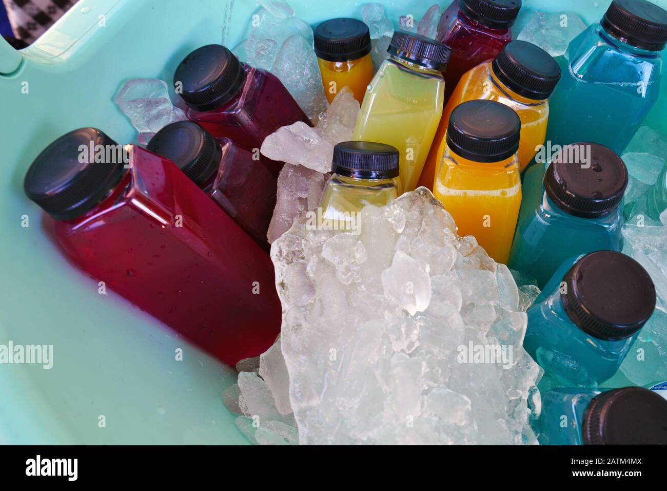 Bottles of colorful cold pressed juice on ice Stock Photo - Alamy