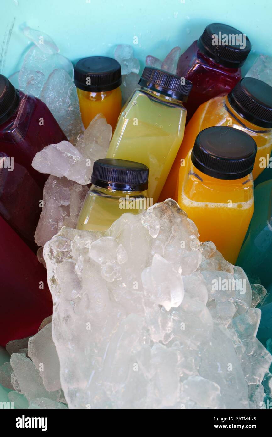 Bottles of colorful cold pressed juice on ice Stock Photo - Alamy
