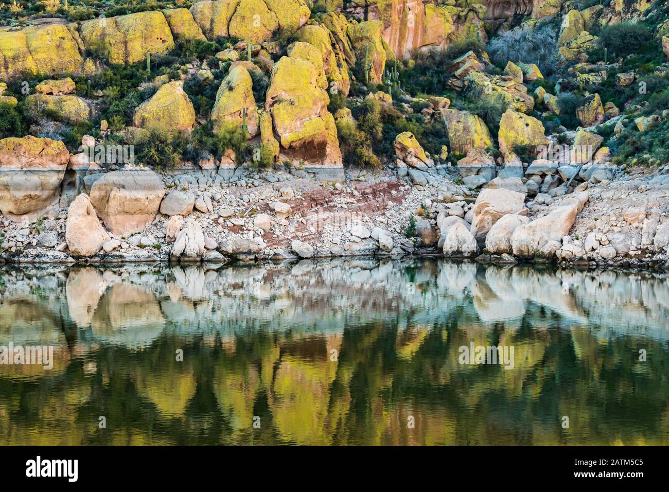 Low water level, bleached rocks, and large boulders covered in yellow ...