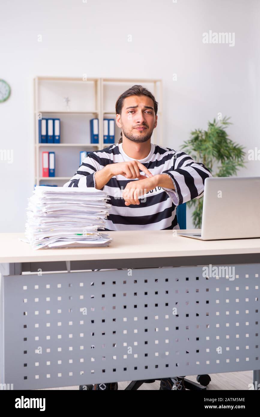 The young employee feeling like prisoner at work Stock Photo - Alamy