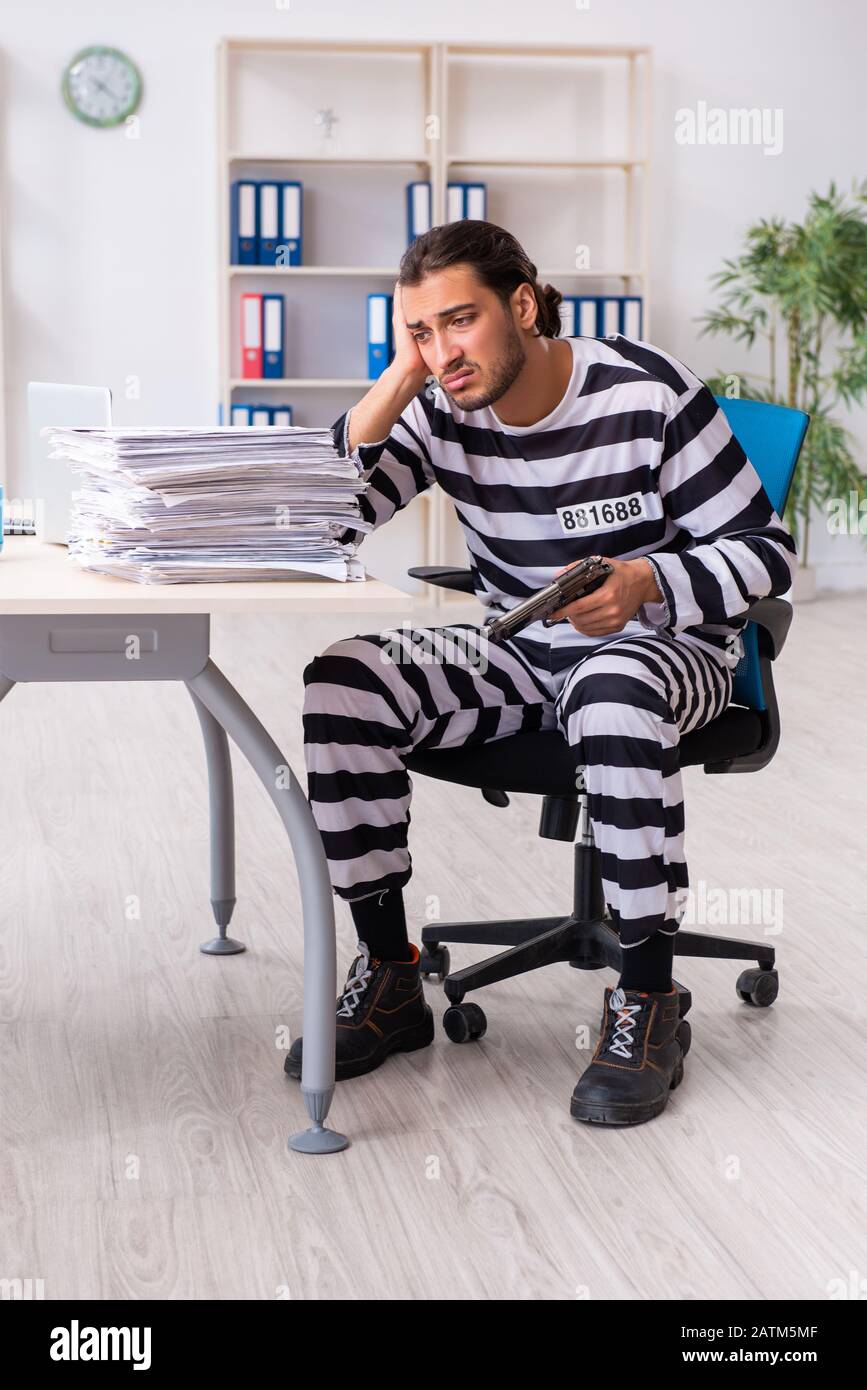 The young employee feeling like prisoner at work Stock Photo - Alamy