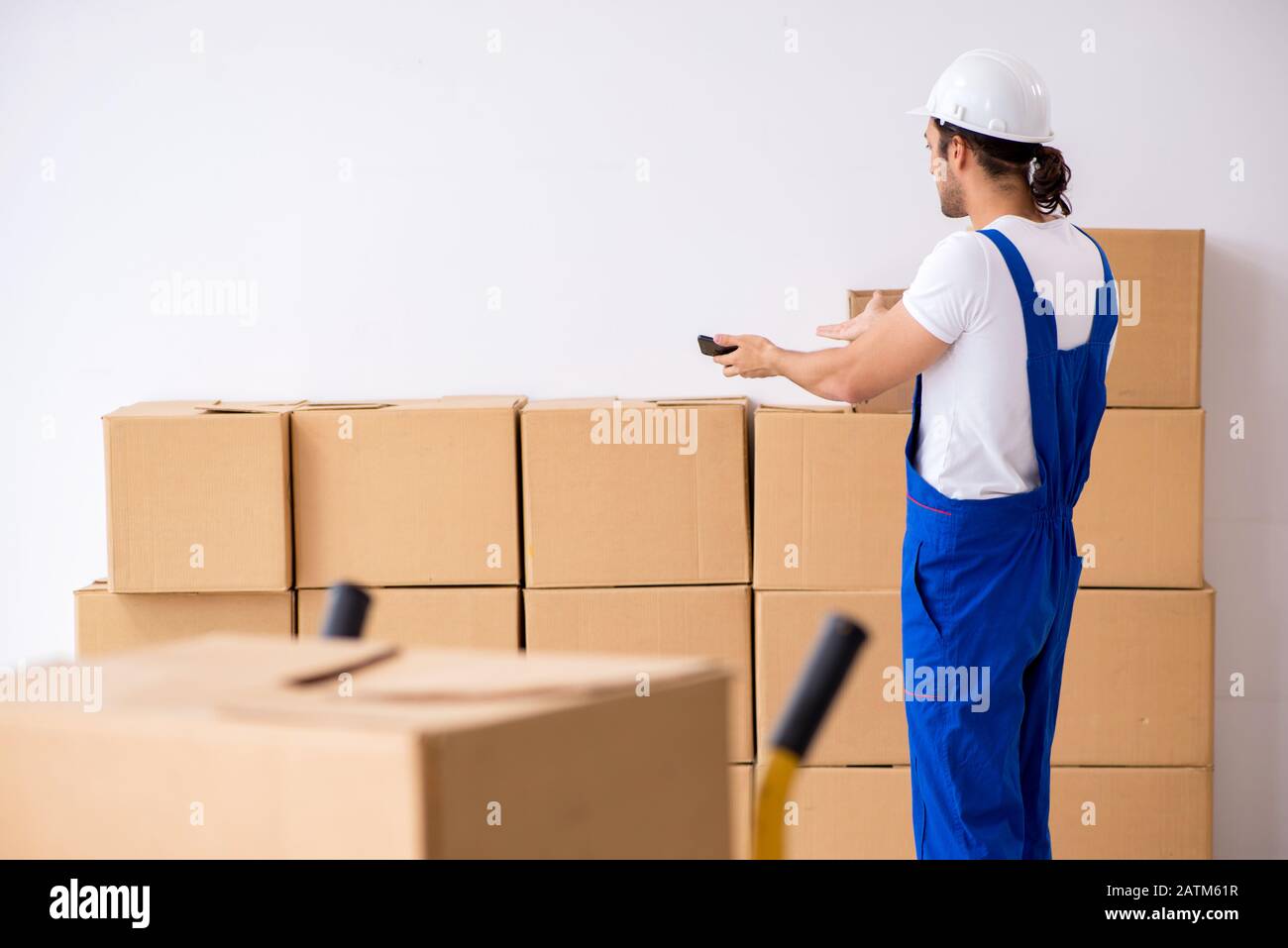 The young male professional mover doing home relocation Stock Photo - Alamy