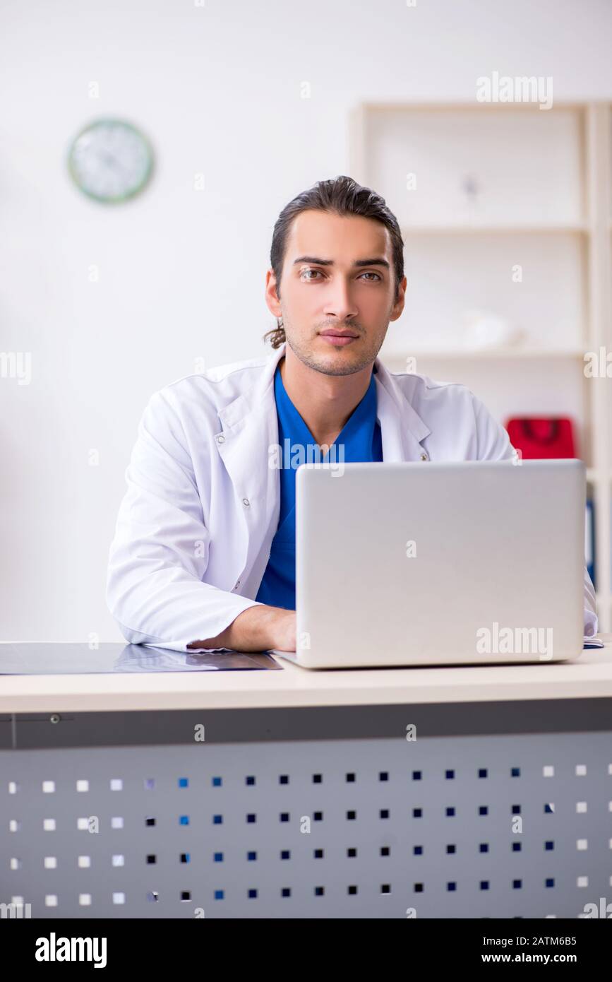 The young male doctor working in the clinic Stock Photo - Alamy