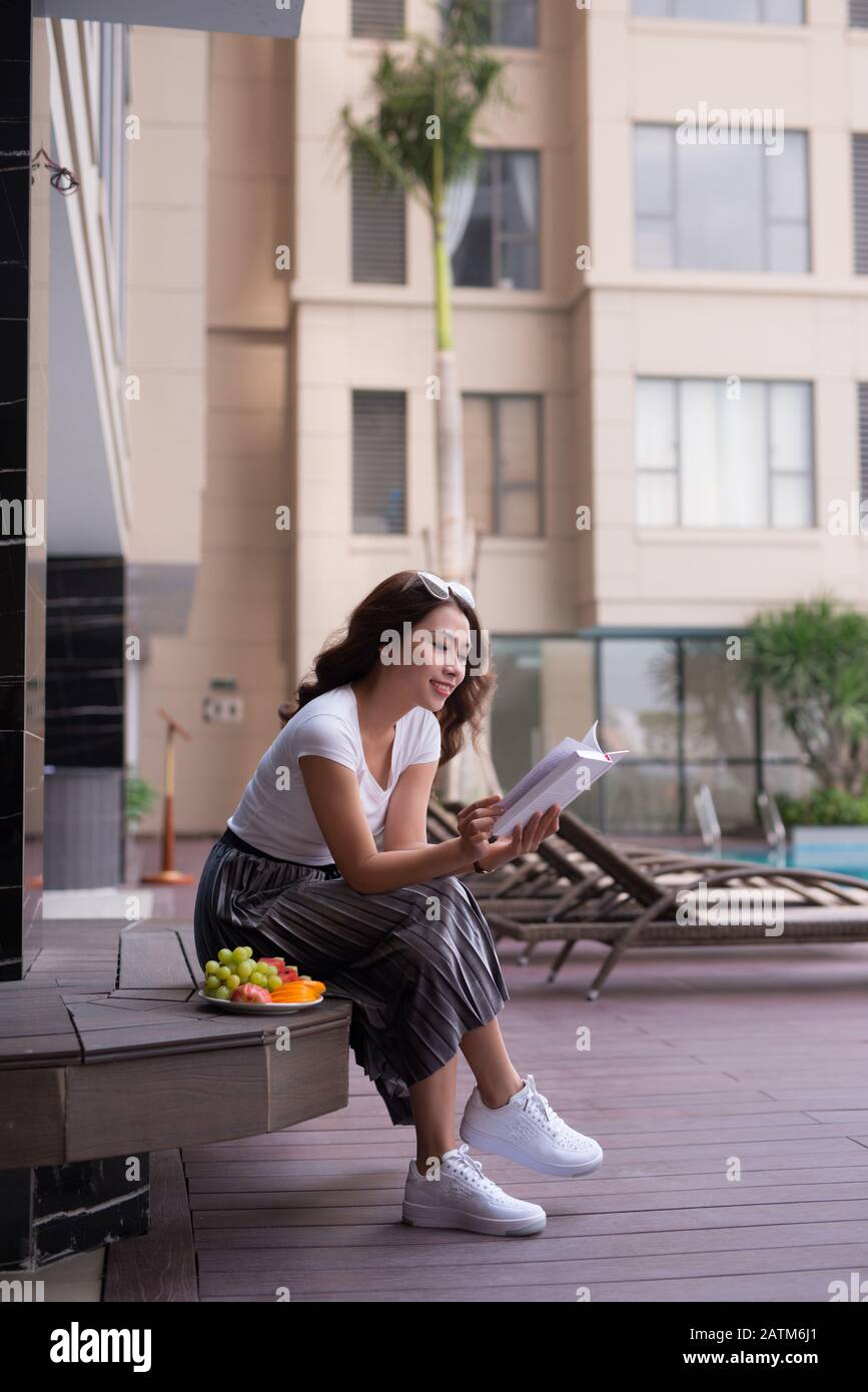 Reading outside pool hi-res stock photography and images - Alamy