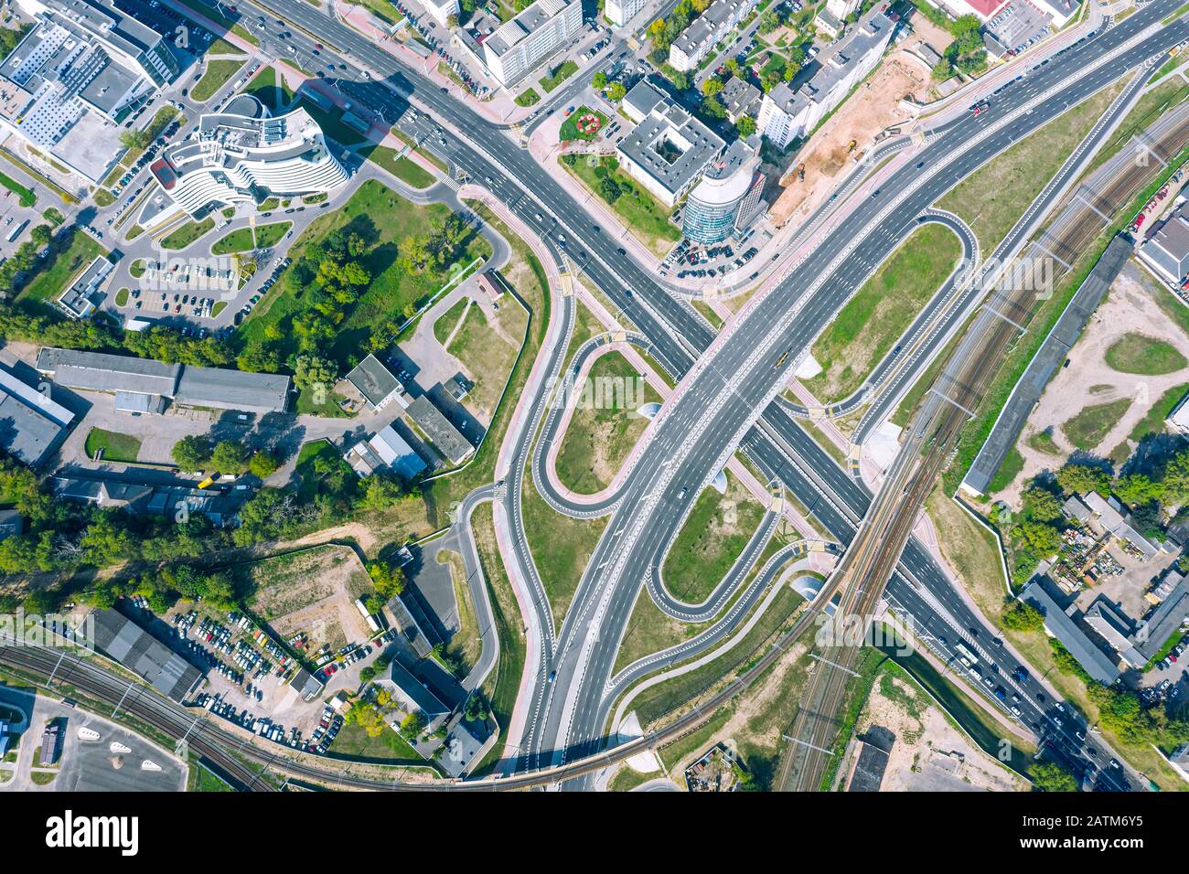 aerial top down view of asphalt road intersection and rail tracks in ...