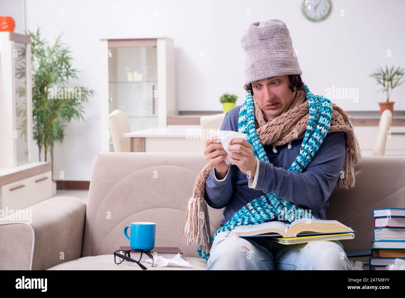 The sick male student suffering at home Stock Photo - Alamy