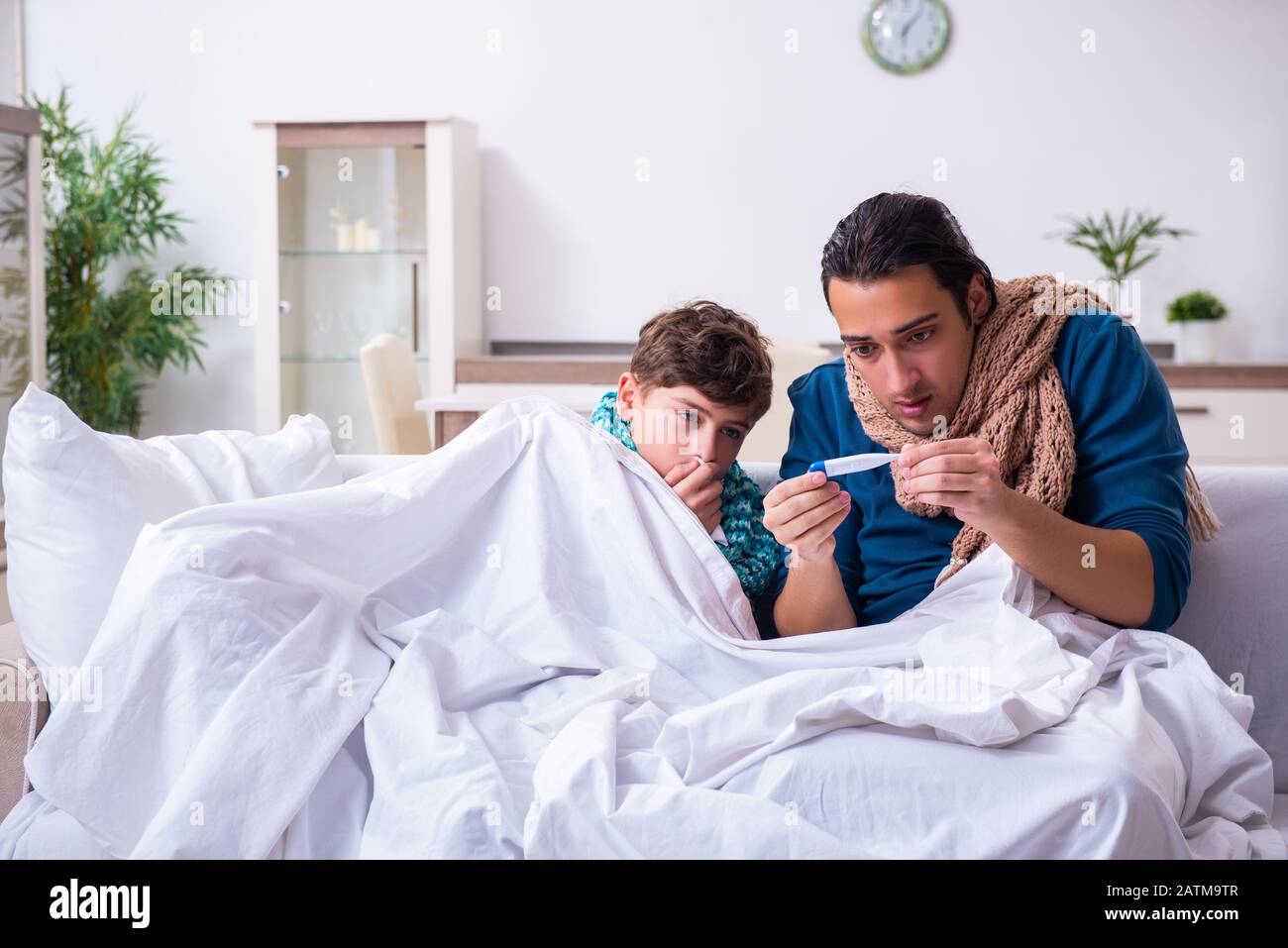 The young father caring for sick son Stock Photo - Alamy