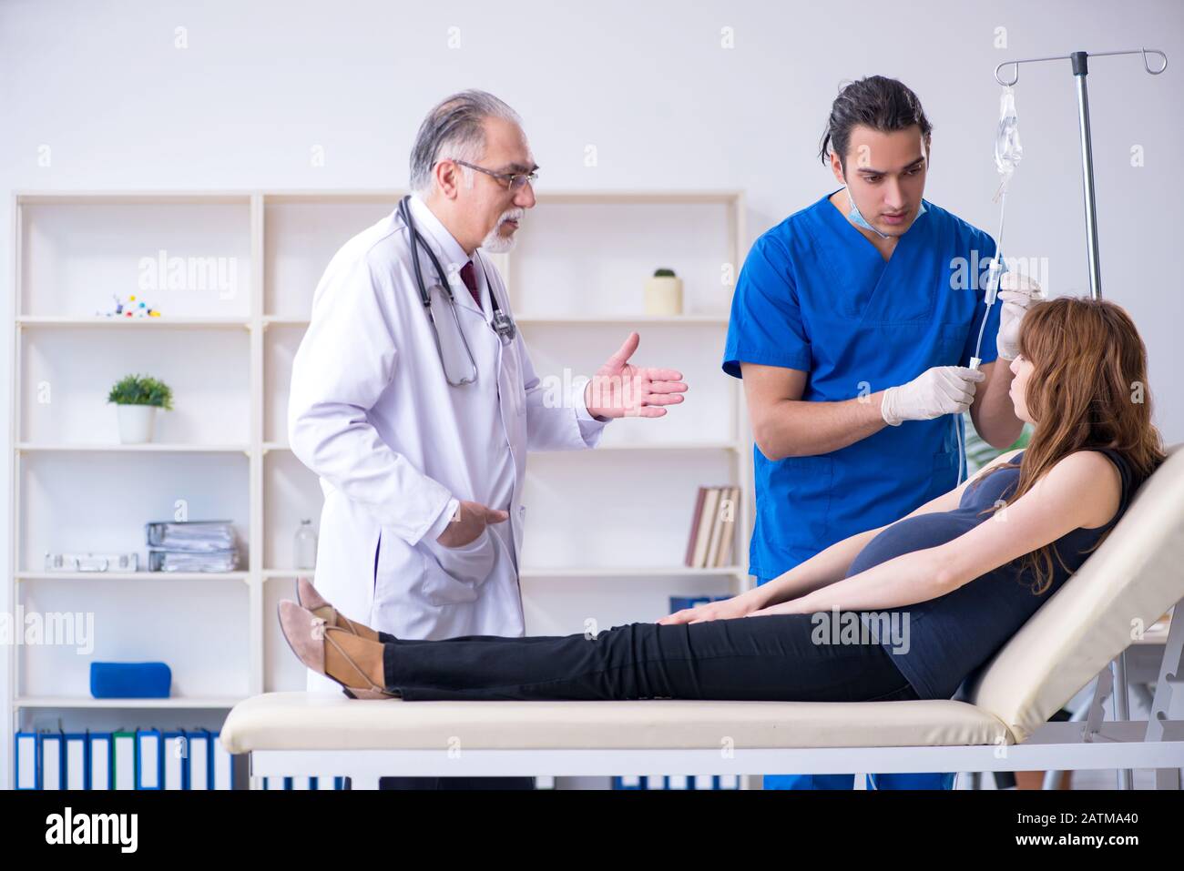 The two doctors examining young woman Stock Photo - Alamy