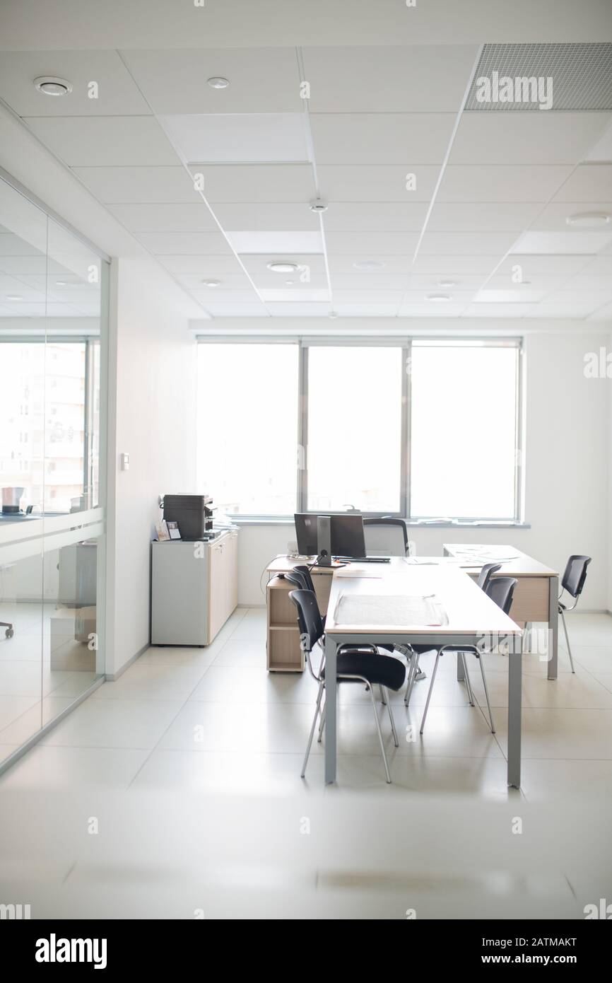 Contemporary interior of empty office room with long table, chairs and ...