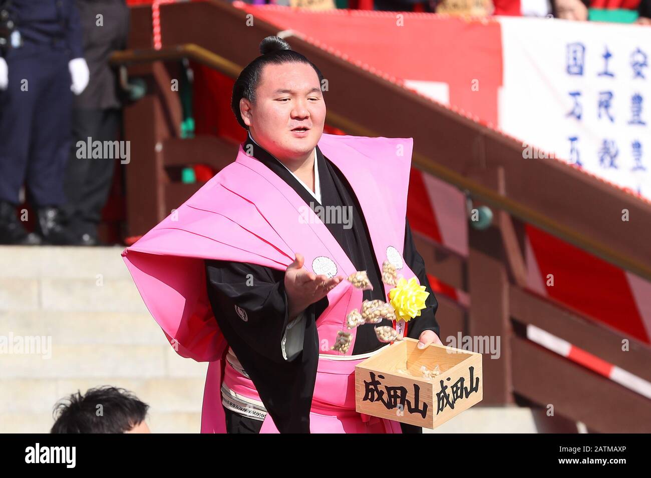 Sumo Yokozuna Hakuho and other invited dignitaries throw bags of beans ...