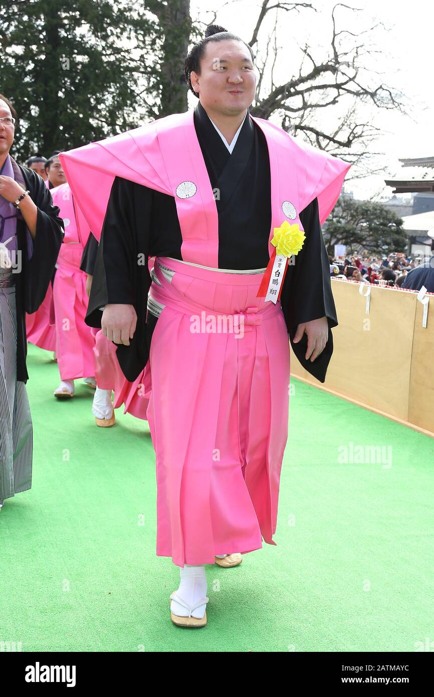 Sumo Yokozuna Hakuho and other invited dignitaries throw bags of beans ...