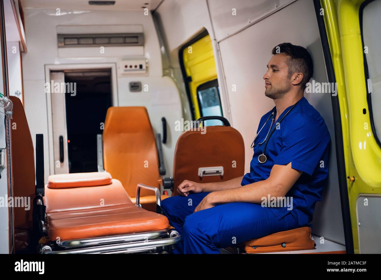 Tired corpsman in medical uniform sits inside the ambulance car Stock ...