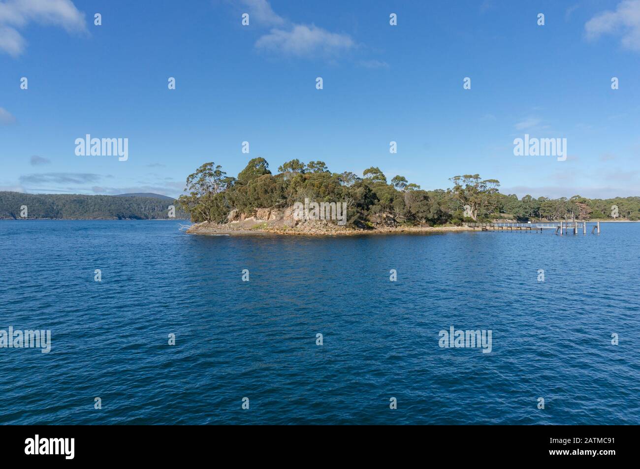 Nature landscape of remote island covered with forest with jetty, pier ...