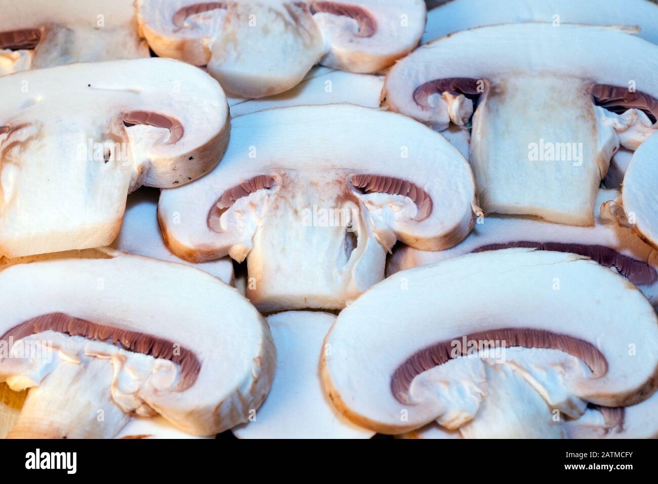Set of fresh whole and sliced champignon mushrooms top view on wooden ...
