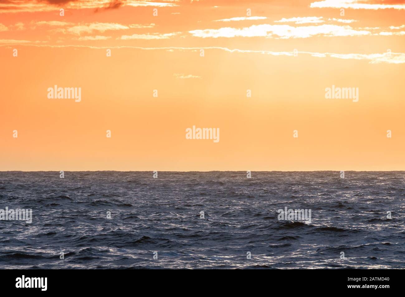 Simple nature background with calm ocean and colorful golden sky ...