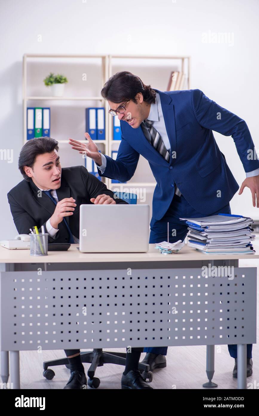 The boss and his male assistant working in the office Stock Photo - Alamy