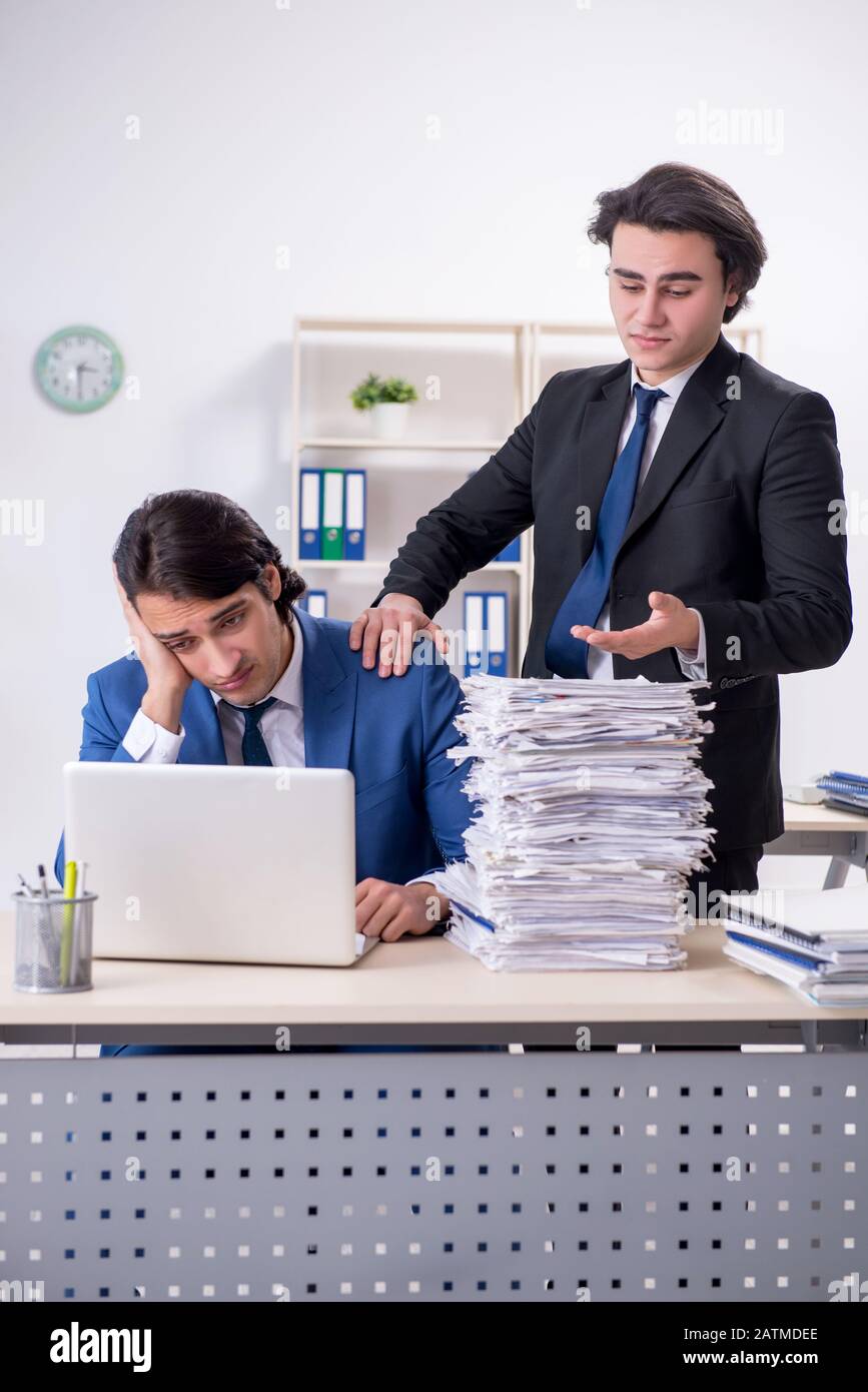 The two male colleagues unhappy with excessive work Stock Photo - Alamy