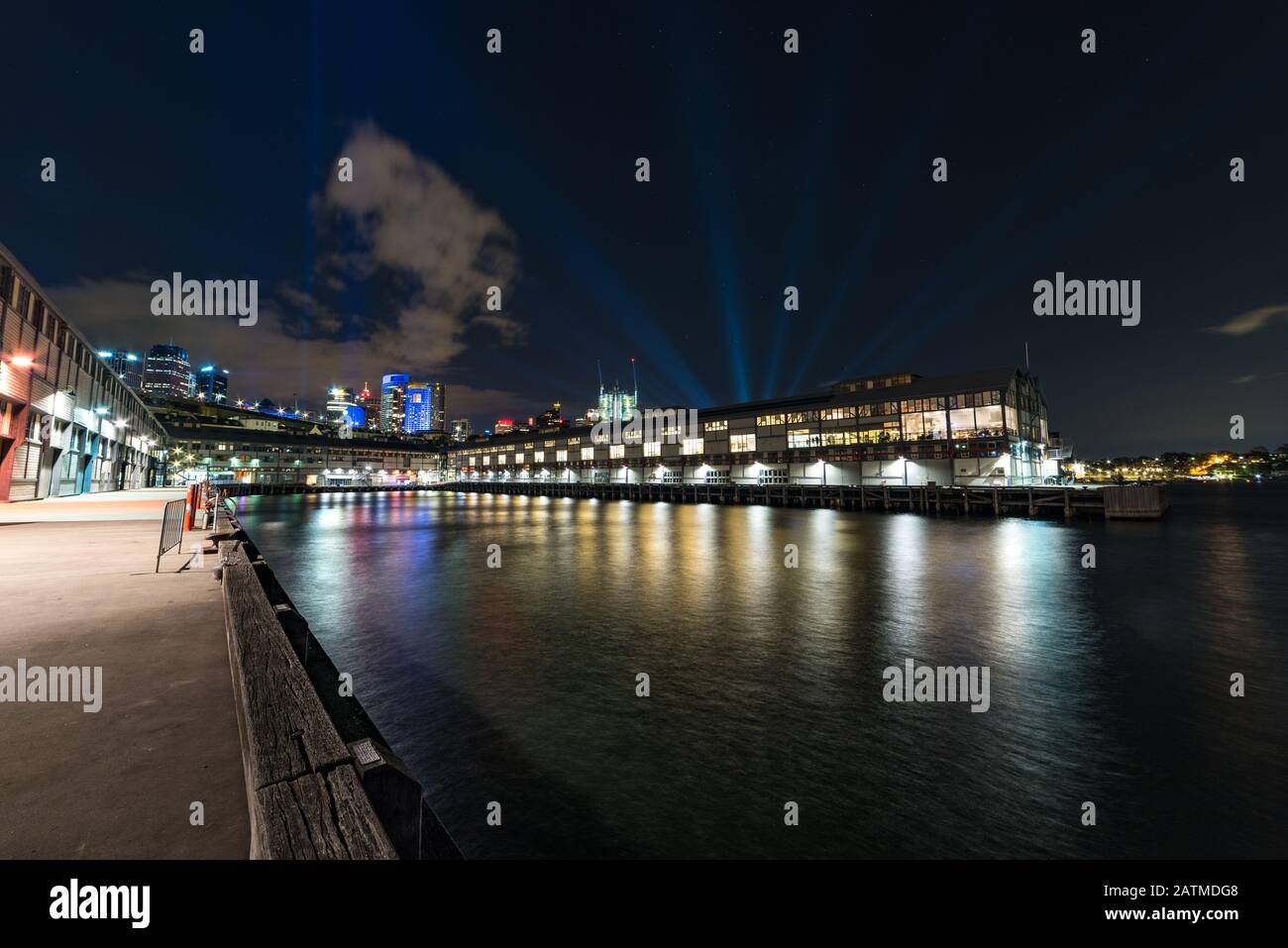 Beautiful urban night scene with water and wharfs illuminated at night ...