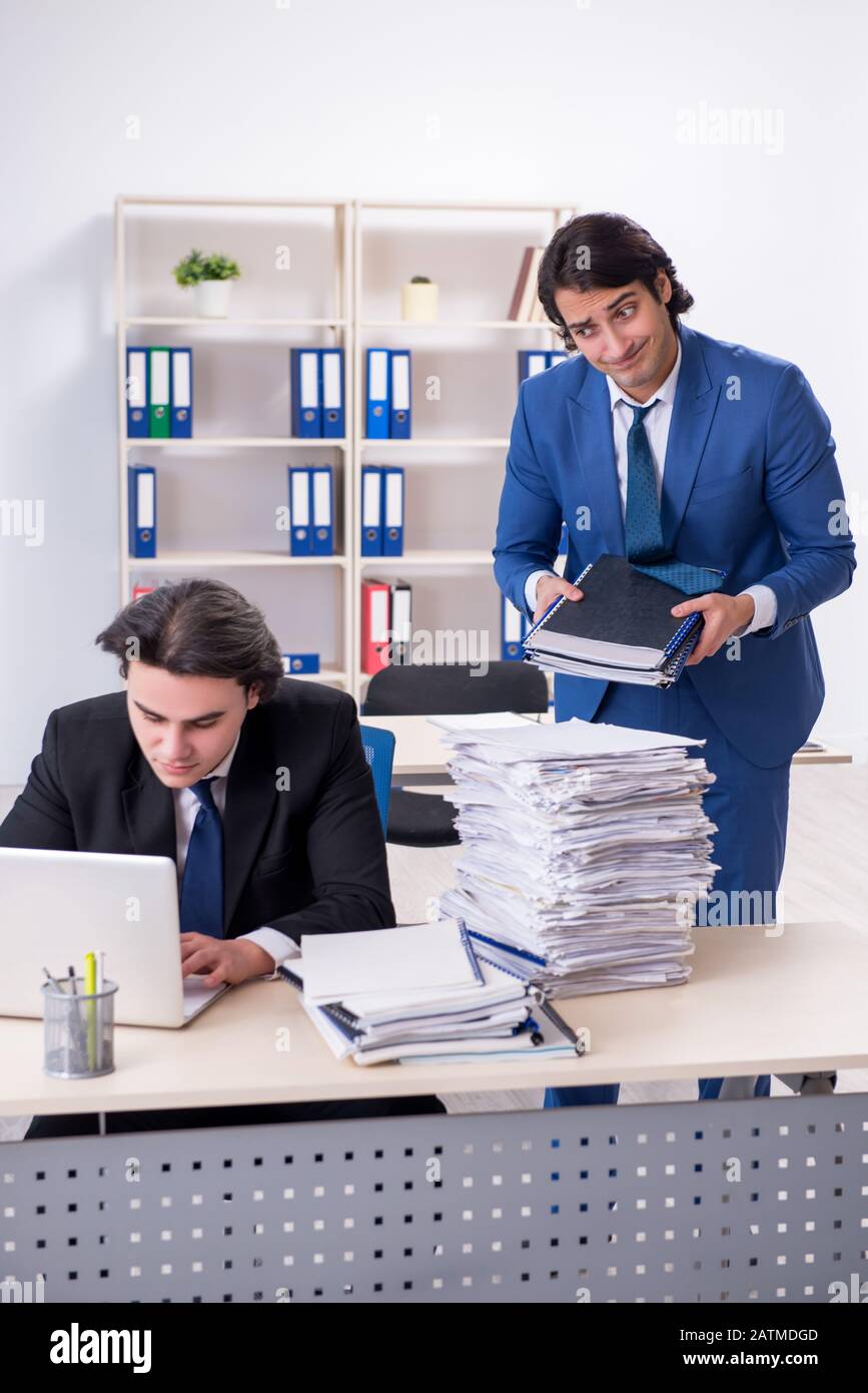 The two male colleagues unhappy with excessive work Stock Photo - Alamy