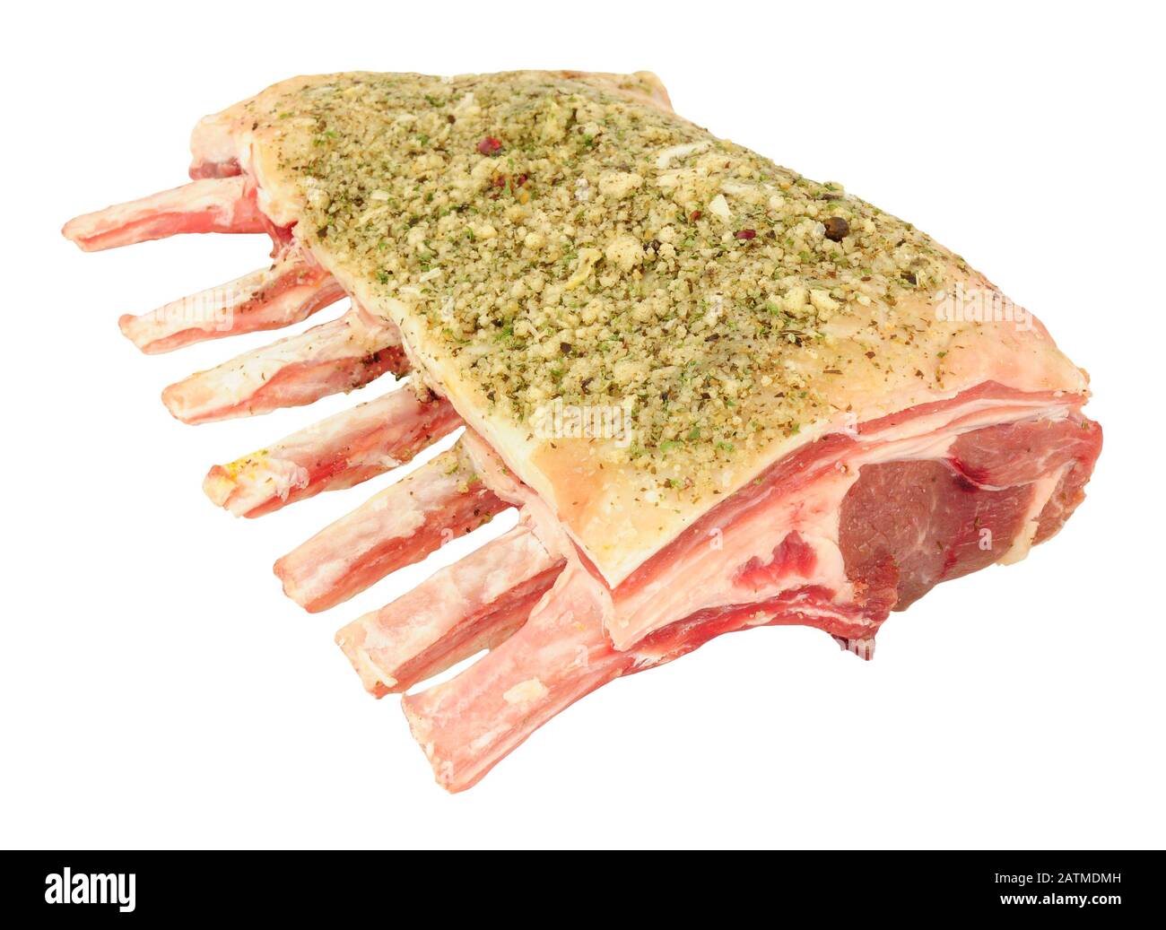 Rack of raw lamb cutlets with herb topping isolated on a white ...