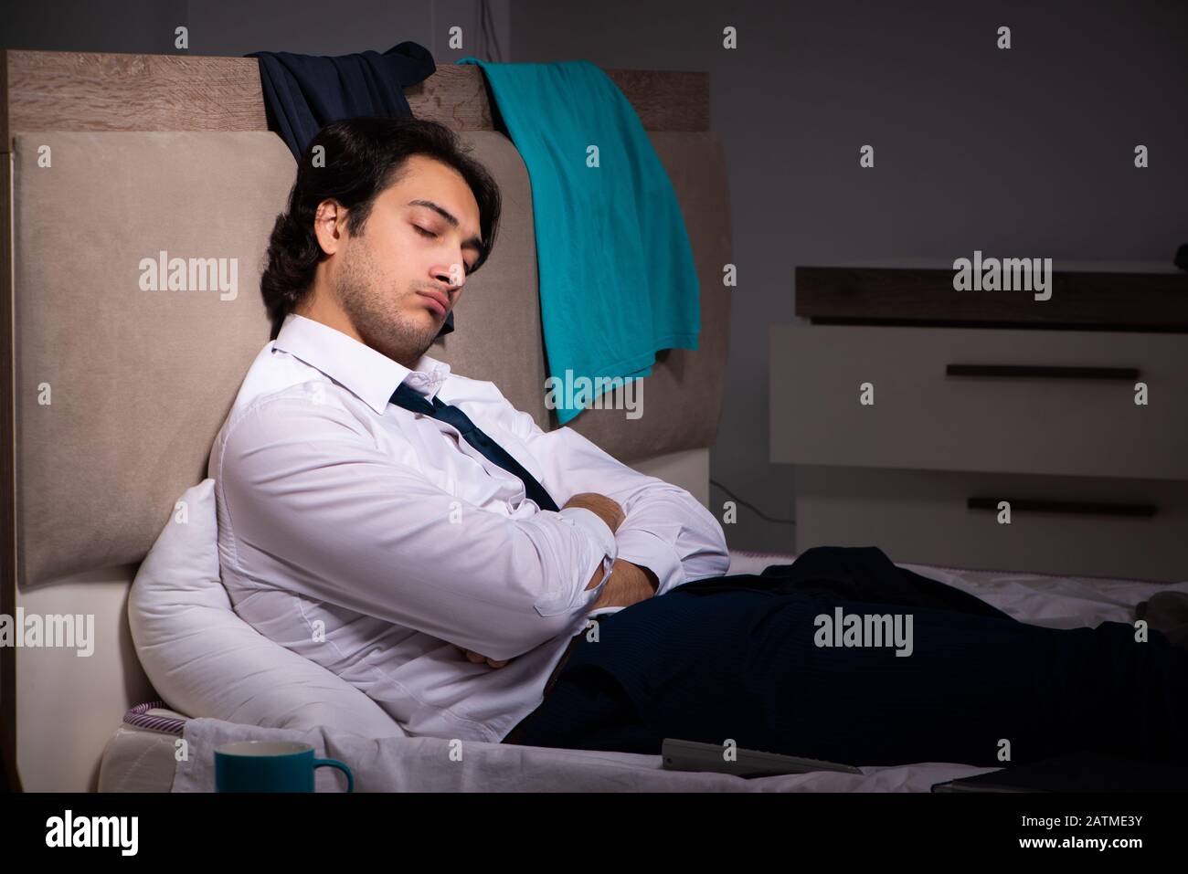 The young employee working at home after night shift Stock Photo - Alamy