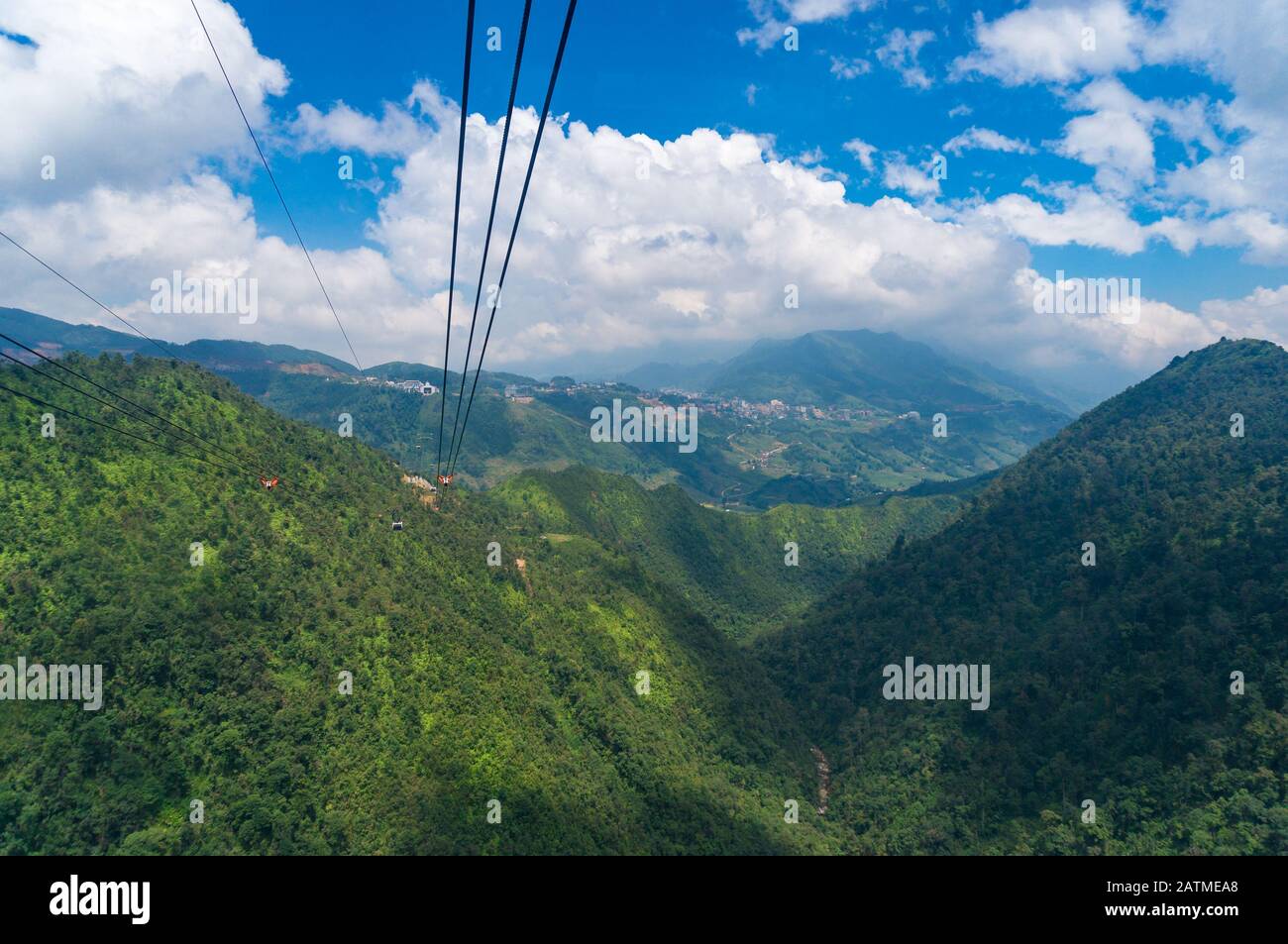Cable car riding over green mountains and mountain valley. Travel ...